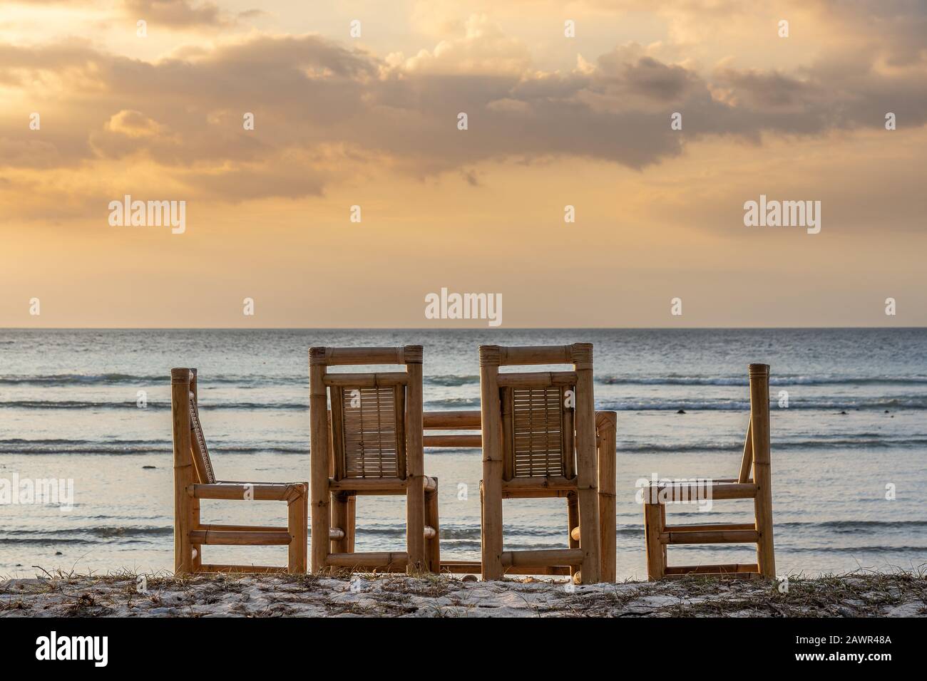 Beautiful view of a dining table on the beach with a scenery of sunset ...