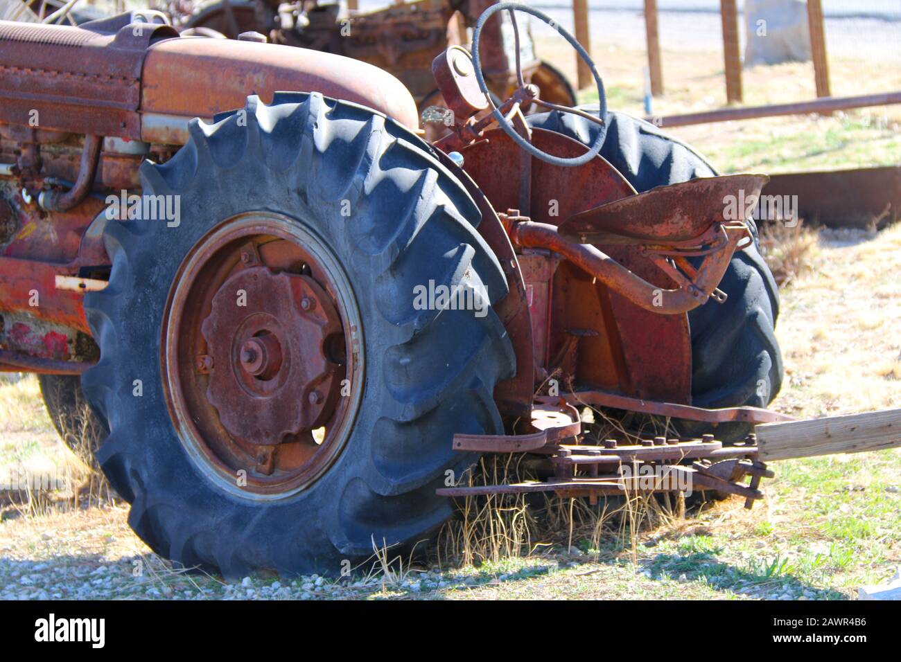 a rusted red farm tractor wheel Stock Photo - Alamy