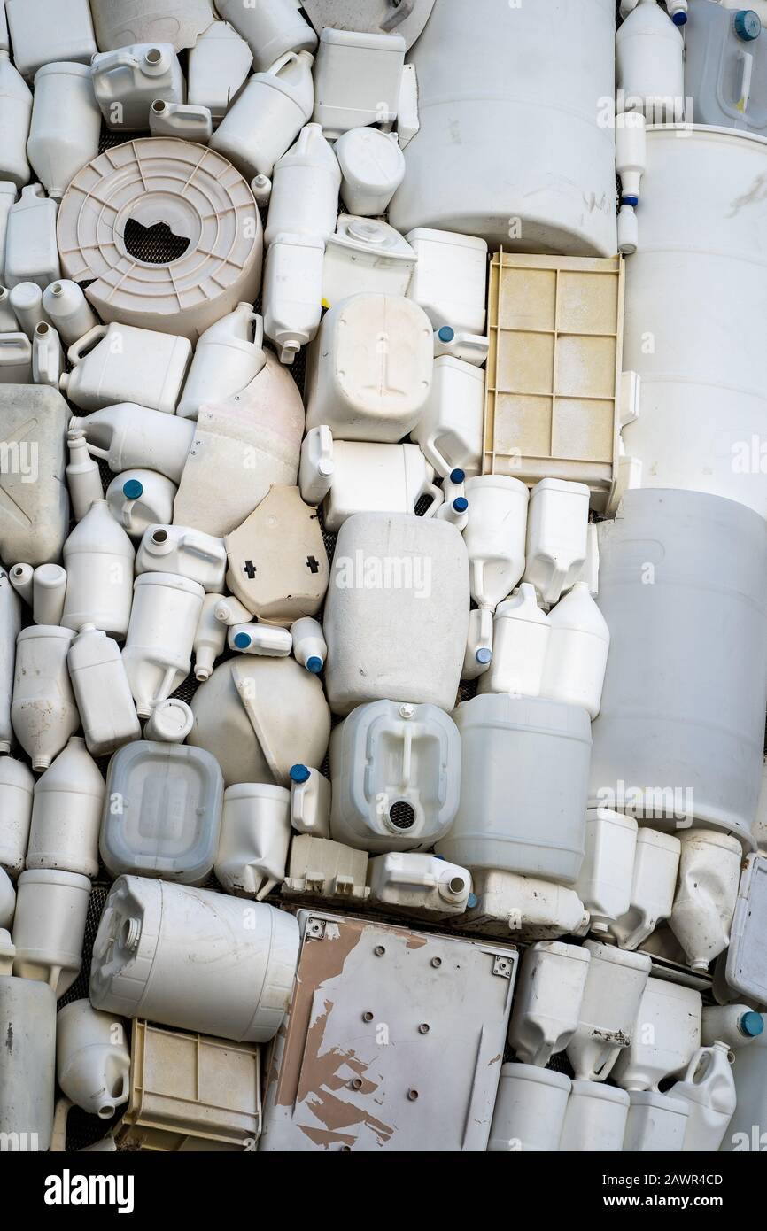 White containers of different sizes and shapes stacked on top of each ...