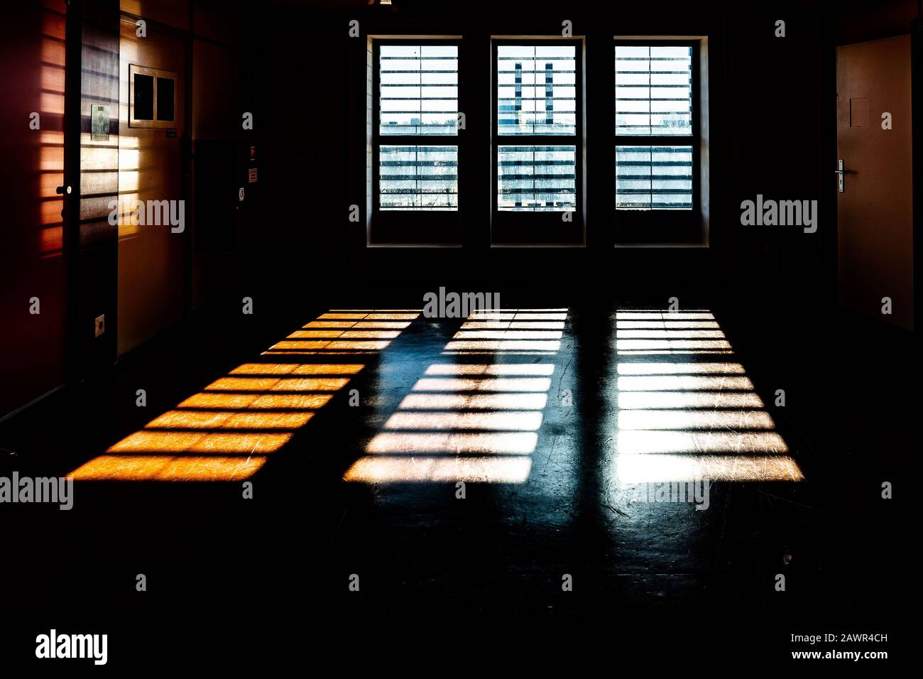 Wide shot of an empty room with sunlight reflecting on the floor coming ...