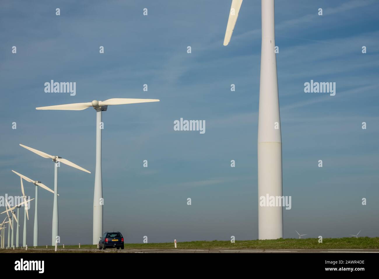 Wind fans behind one another under a blue sky Stock Photo - Alamy