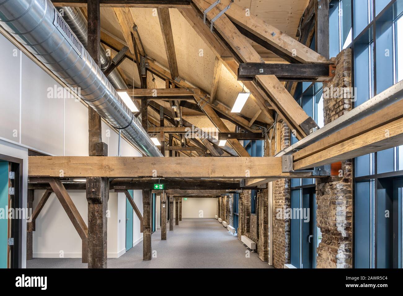 Wide shot of wooden beams inside of a building with windows Stock Photo ...