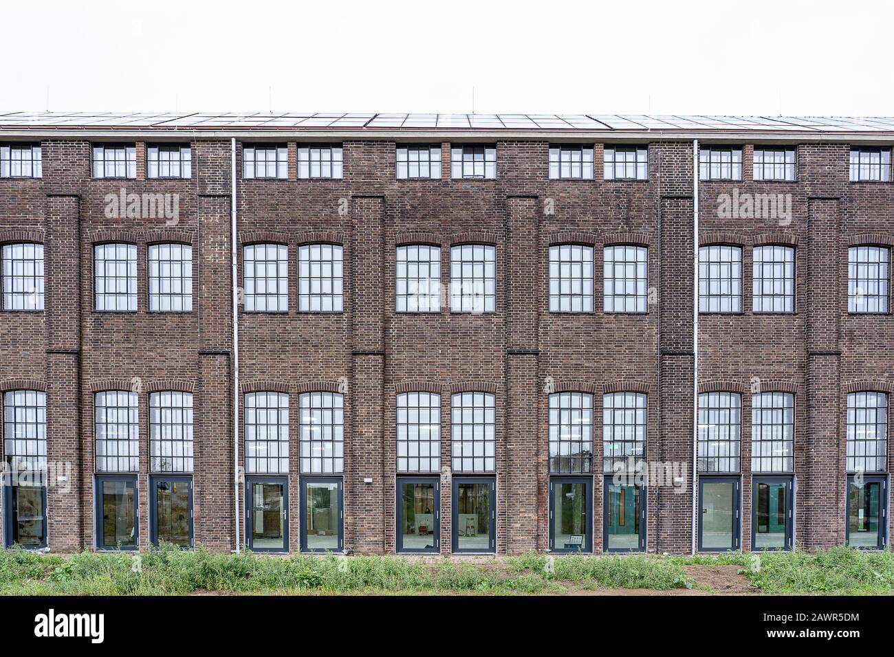 Great shot of a warehouse with glass windows and brick exterior walls ...
