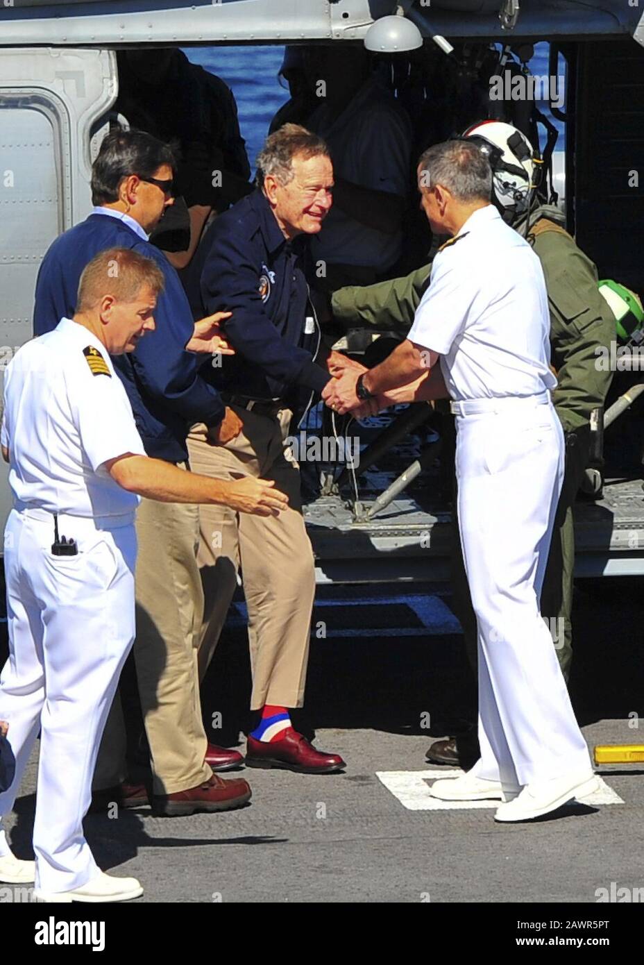 Former President George H.W. Bush arrives aboard the aircraft carrier ...
