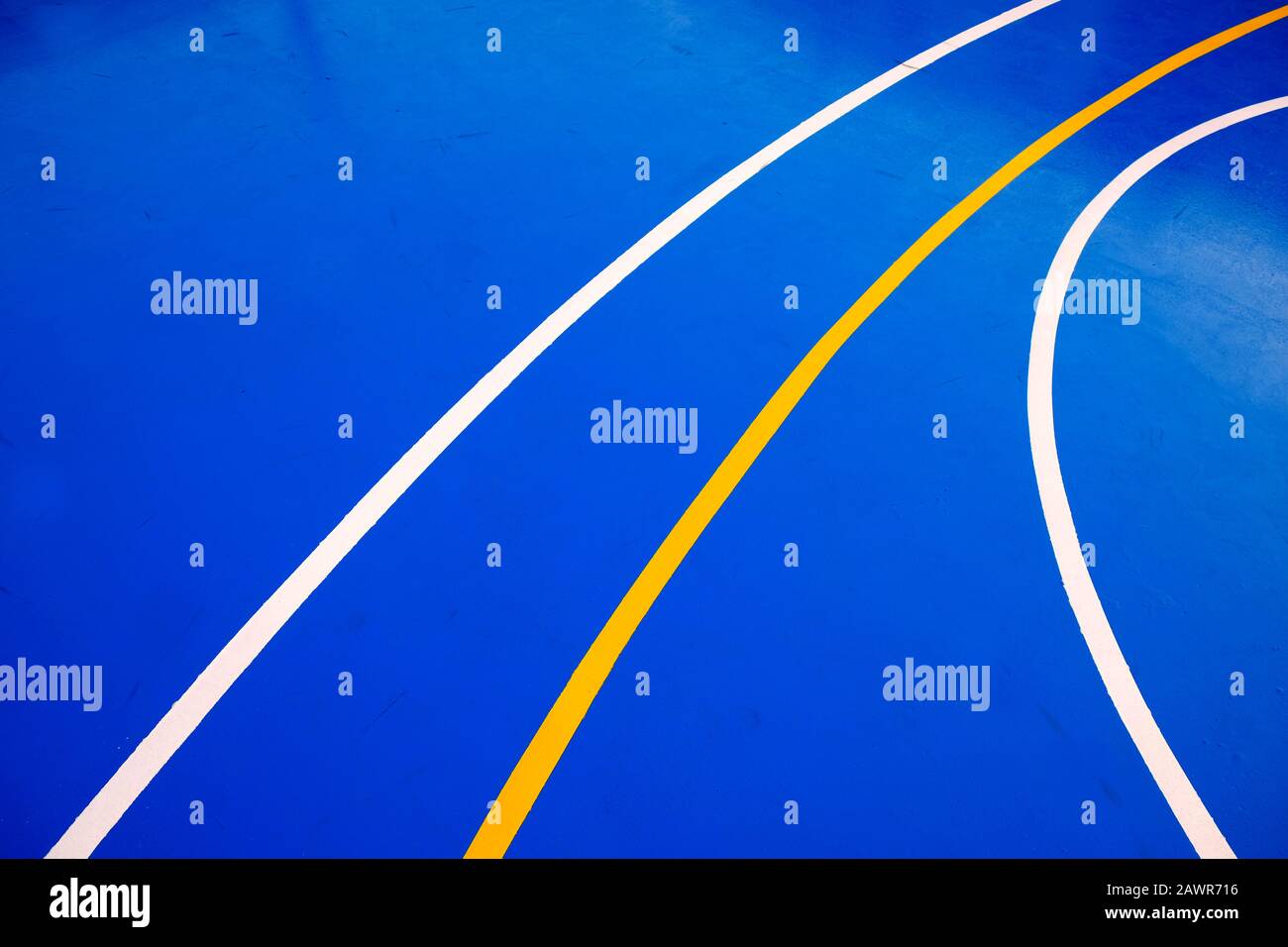 Sports pitch blue field surface with curved white and yellow touchlines ...