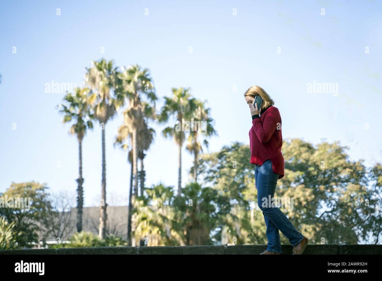 Woman on a phone call distracted on her vacation Stock Photo - Alamy