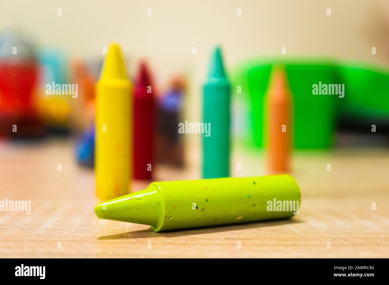 Colorful crayons on the ground of the kids' room Stock Photo - Alamy