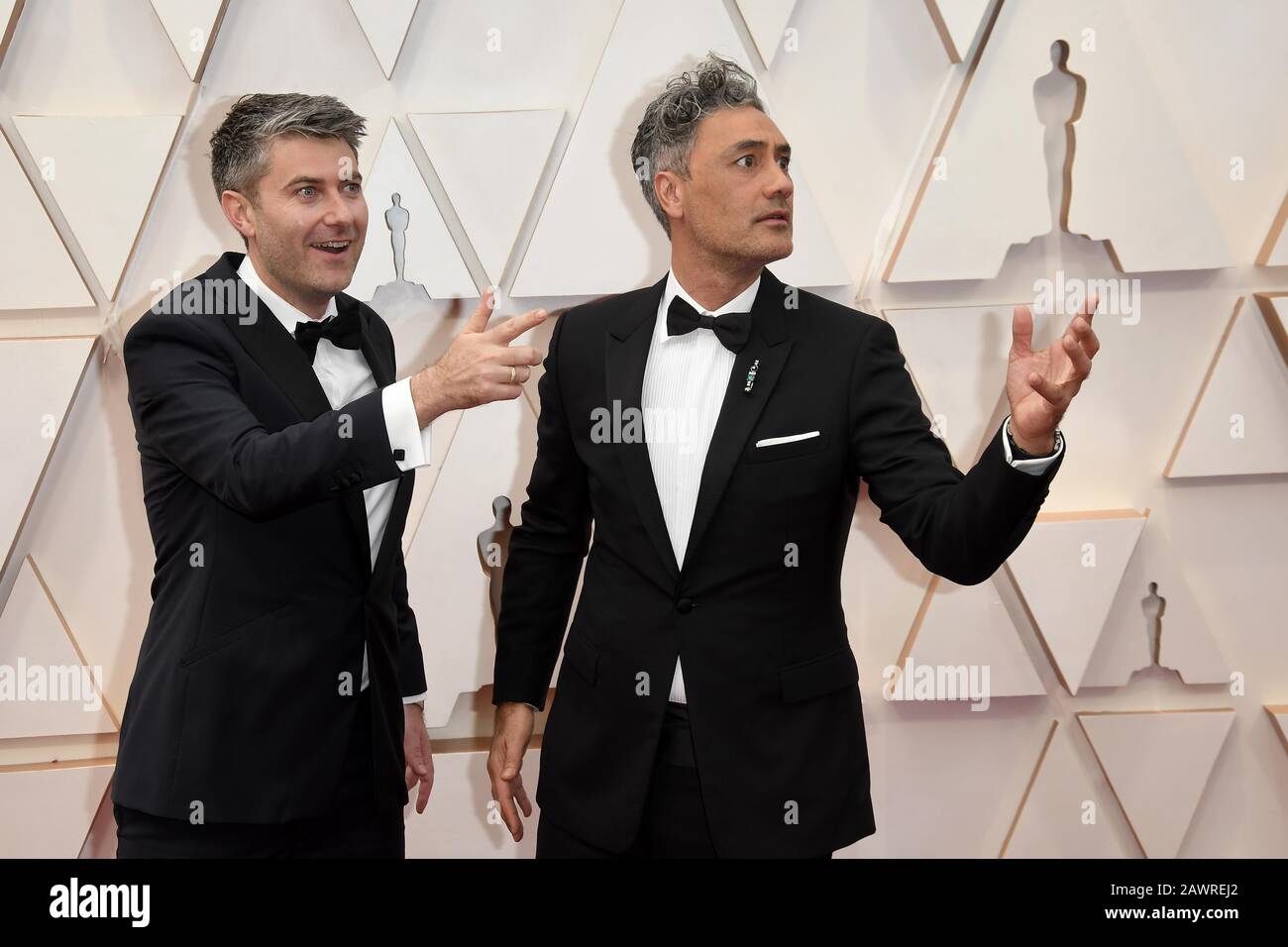 Carthew Neal and Taika Waititi walking on the red carpet at the 92nd ...