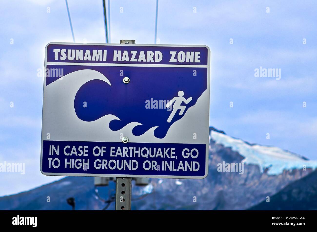 A tsunami hazard zone sign warning along the coast Stock Photo - Alamy
