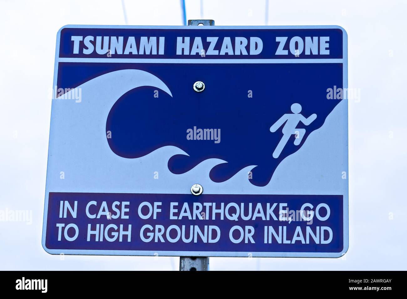 A tsunami hazard zone sign warning along the coast Stock Photo - Alamy