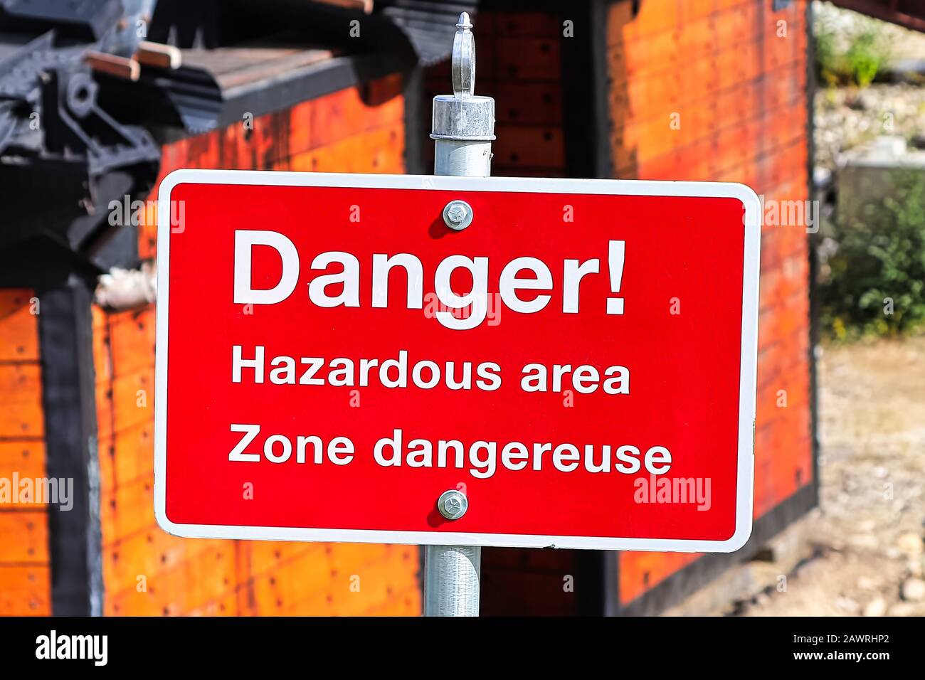 A red danger hazardous area sign in english and french Stock Photo - Alamy