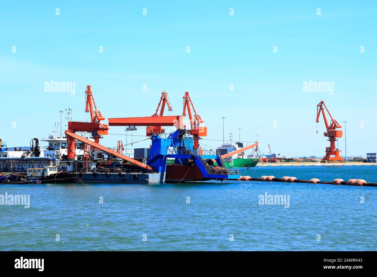 In freight terminal, gantry crane and cargo ships are in loading and ...