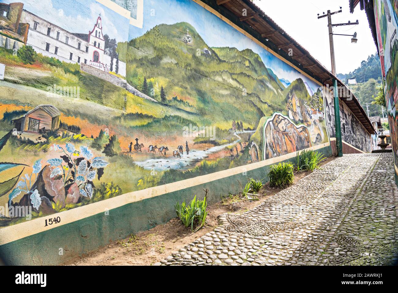 A mural painted on a building celebrating the history of Angangueo ...