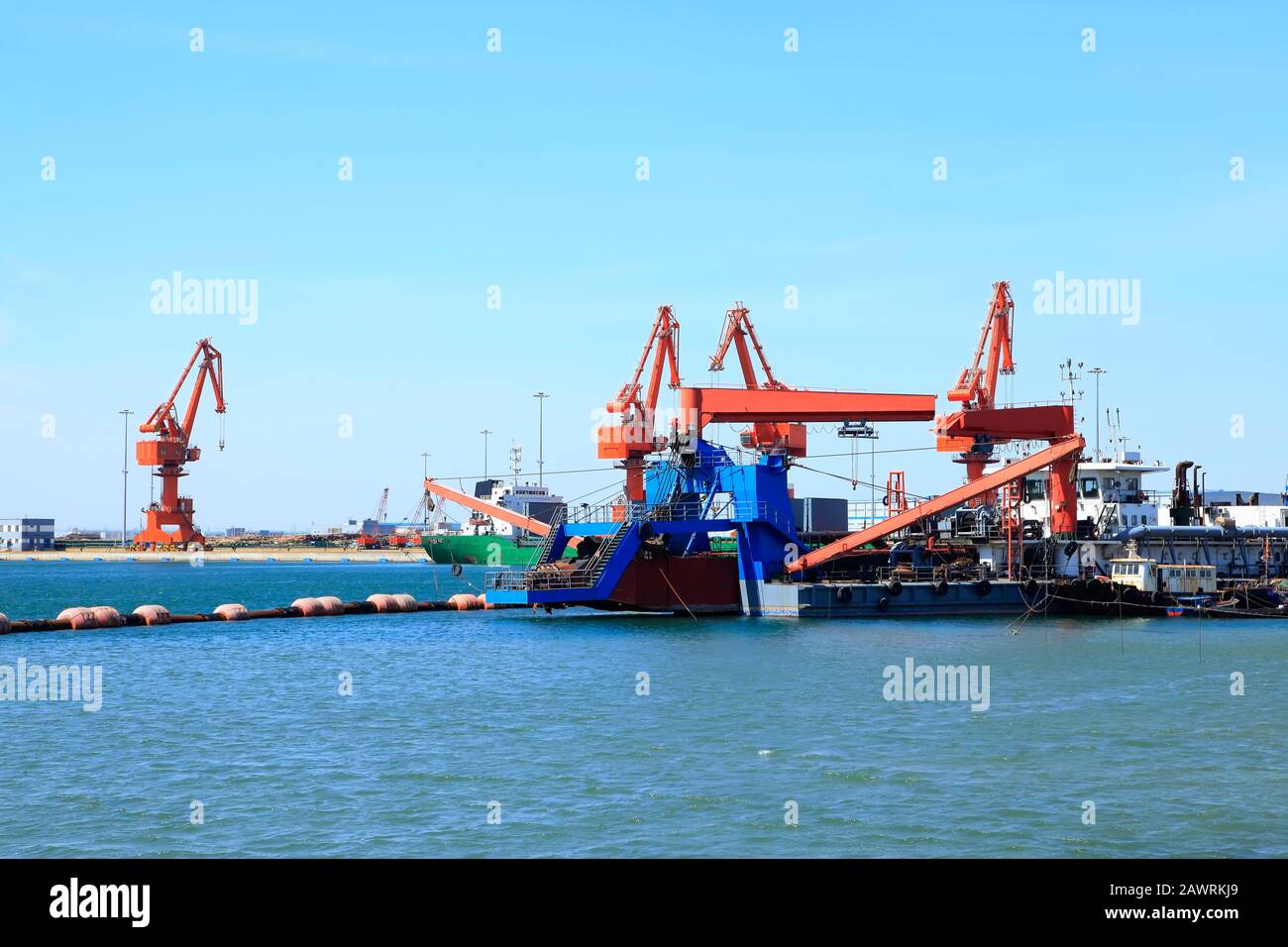 In freight terminal, gantry crane and cargo ships are in loading and ...