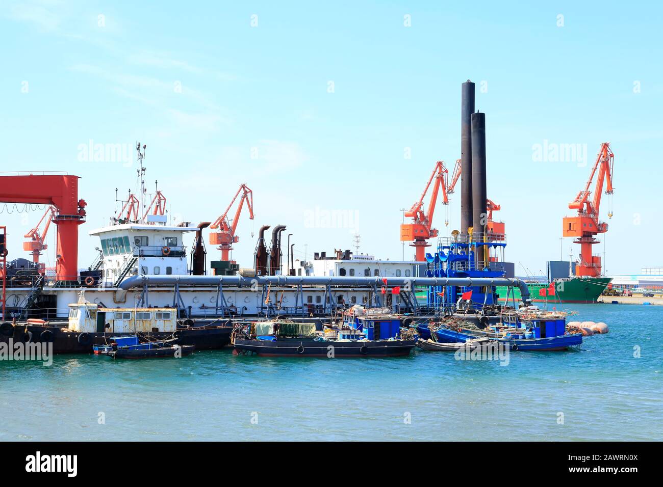 In freight terminal, gantry crane and cargo ships are in loading and ...