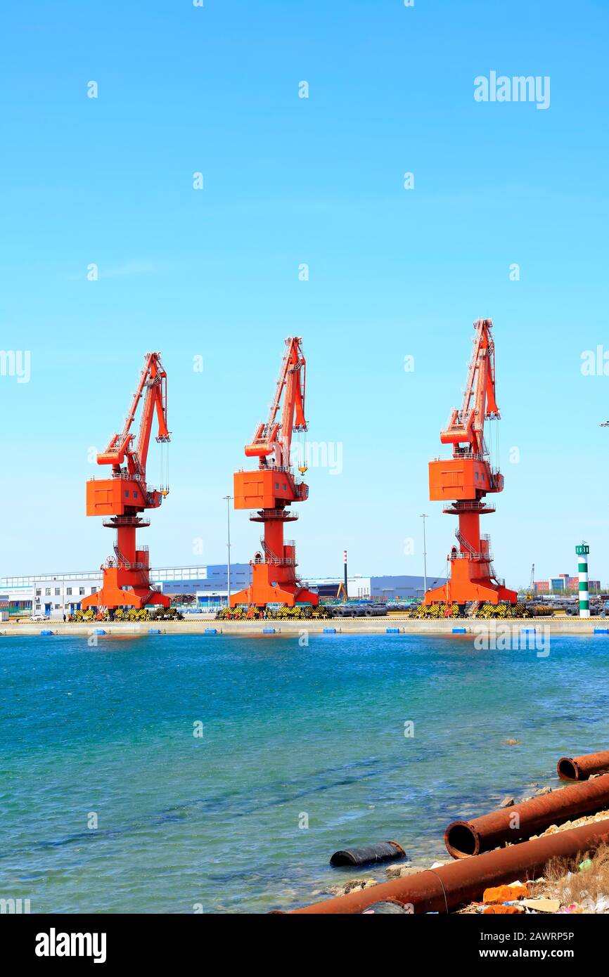 In freight terminal, gantry crane and cargo ships are in loading and ...