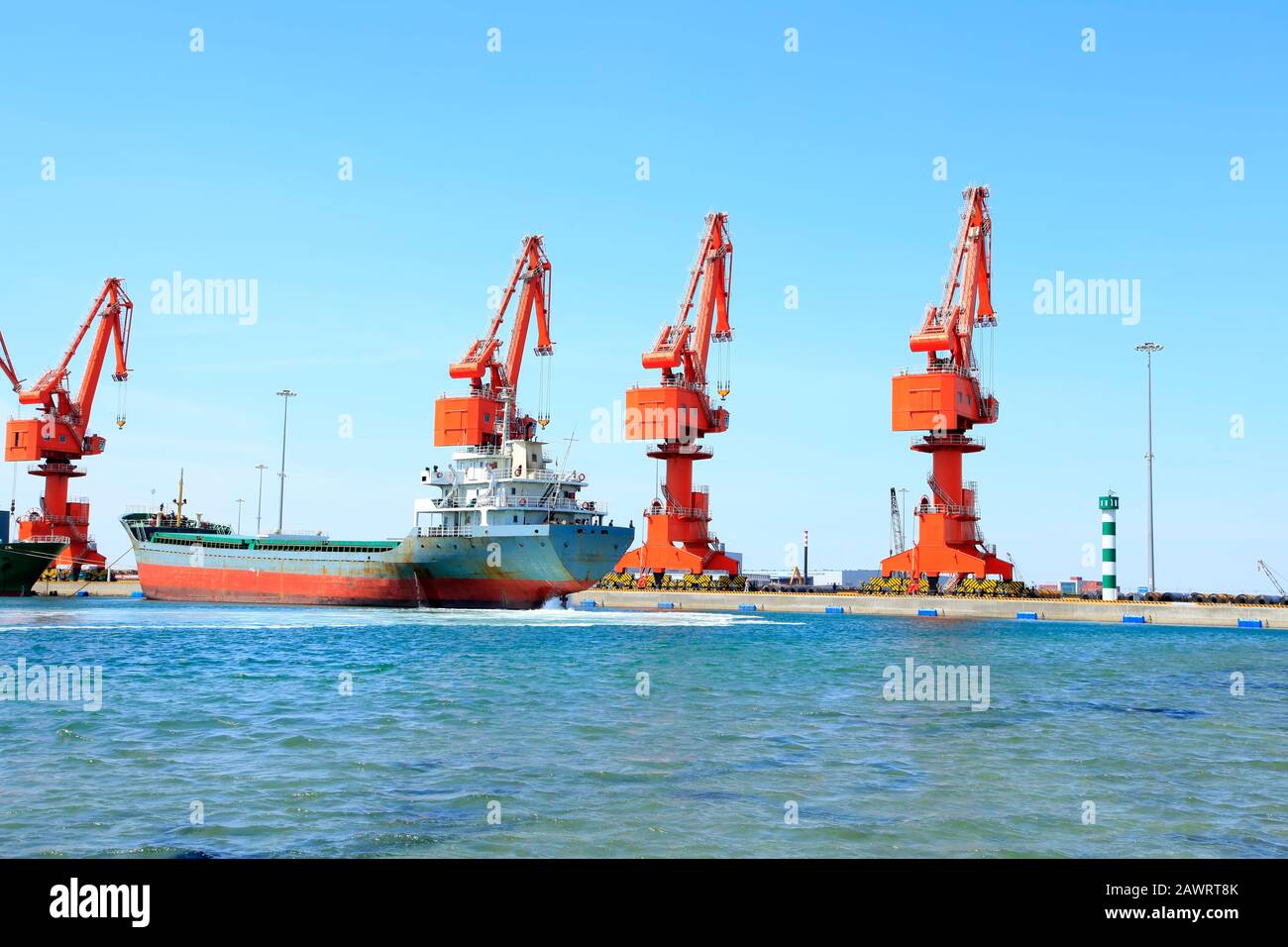 In freight terminal, gantry crane and cargo ships are in loading and ...