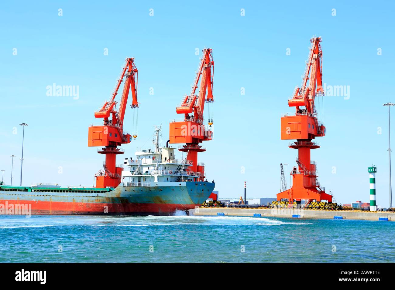 In freight terminal, gantry crane and cargo ships are in loading and ...