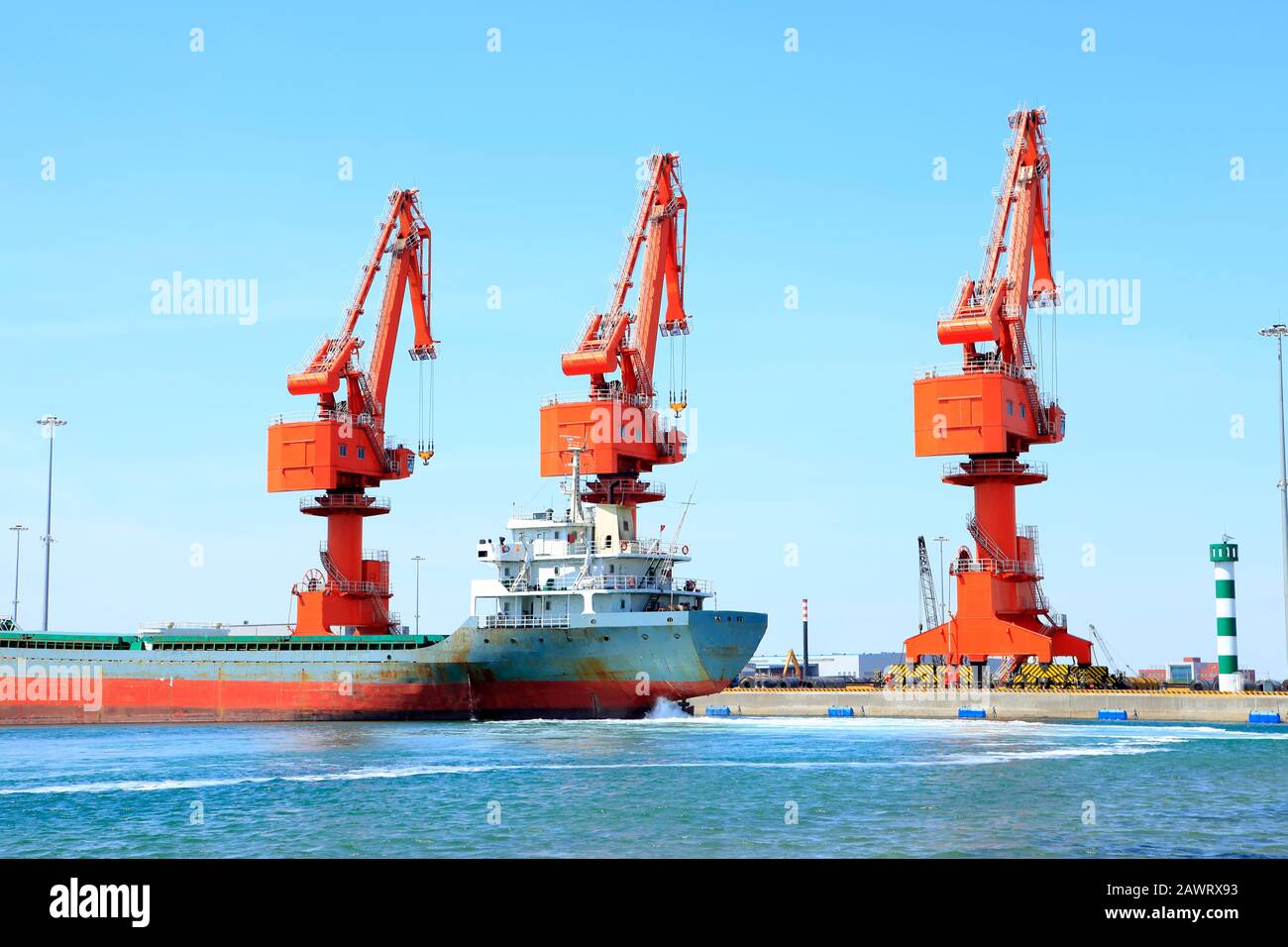 In freight terminal, gantry crane and cargo ships are in loading and ...