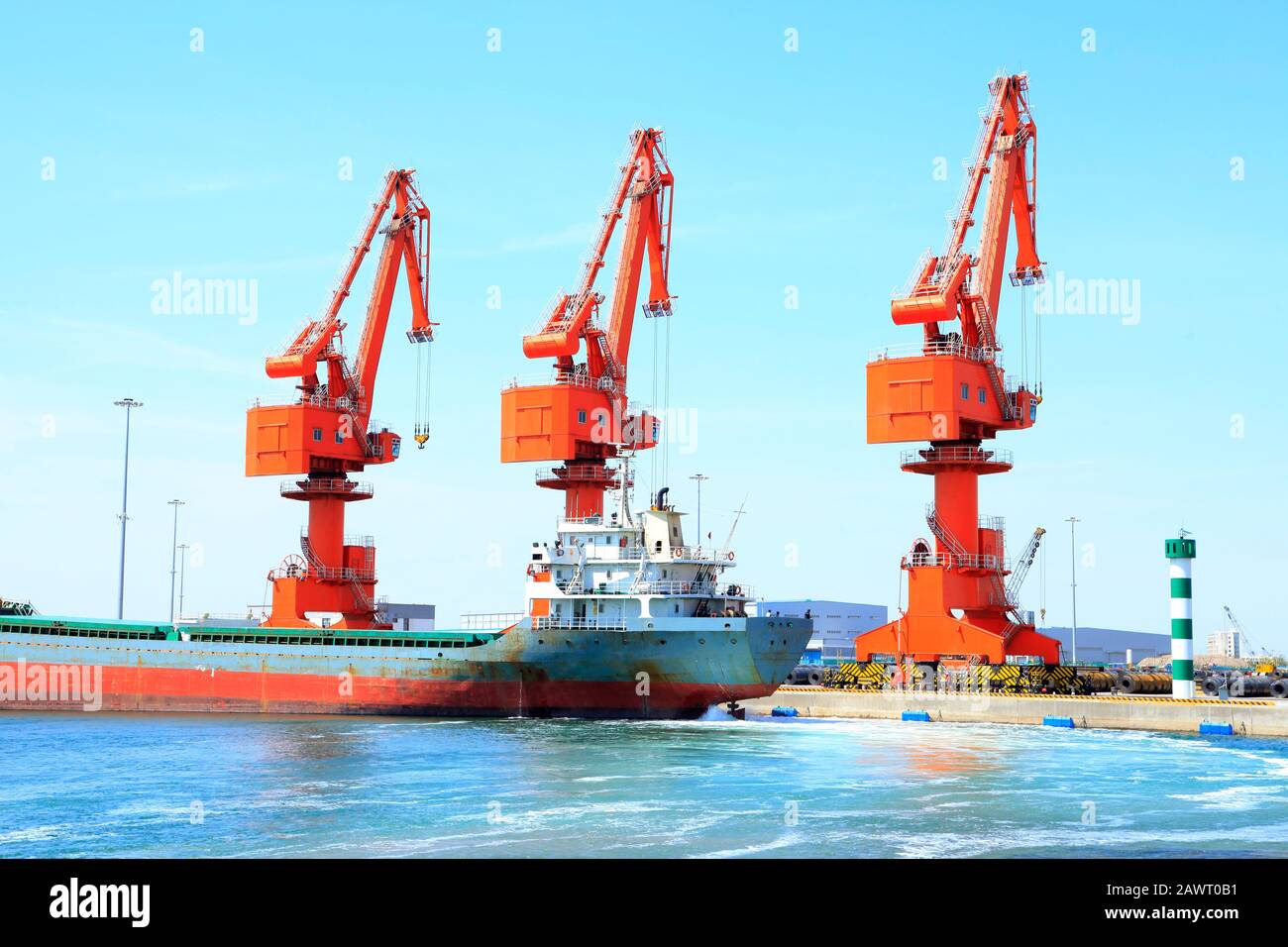 In freight terminal, gantry crane and cargo ships are in loading and ...