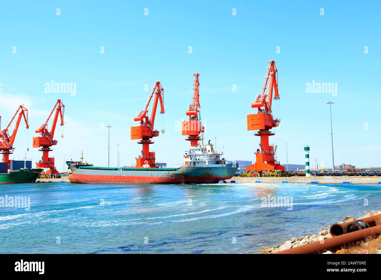 In freight terminal, gantry crane and cargo ships are in loading and ...