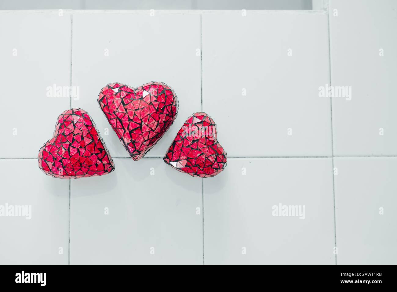 three red hearts of different sizes on a white background Stock Photo ...