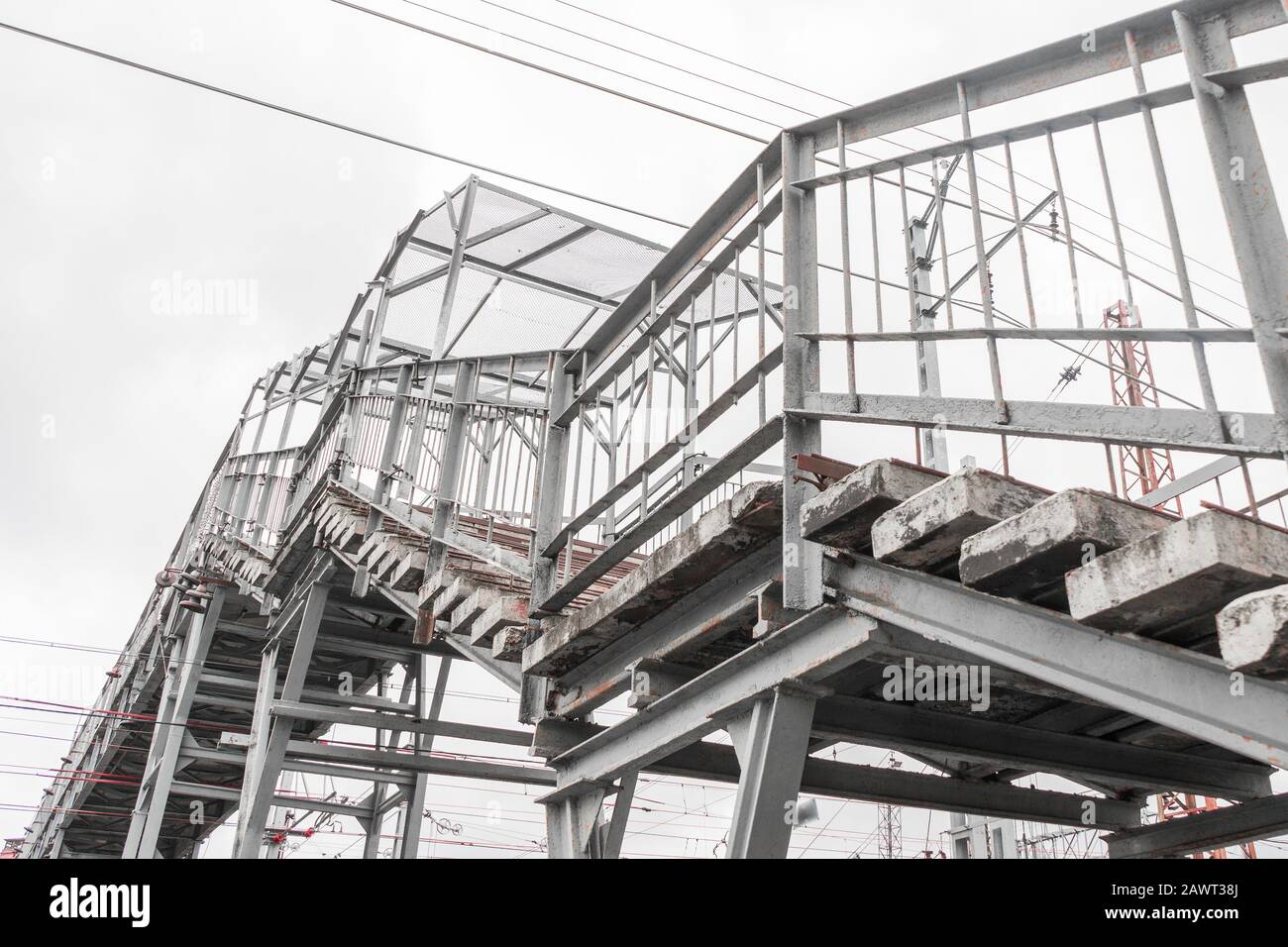 Fragment of staircase of pedestrian bridge over railway. Rusty metal ...