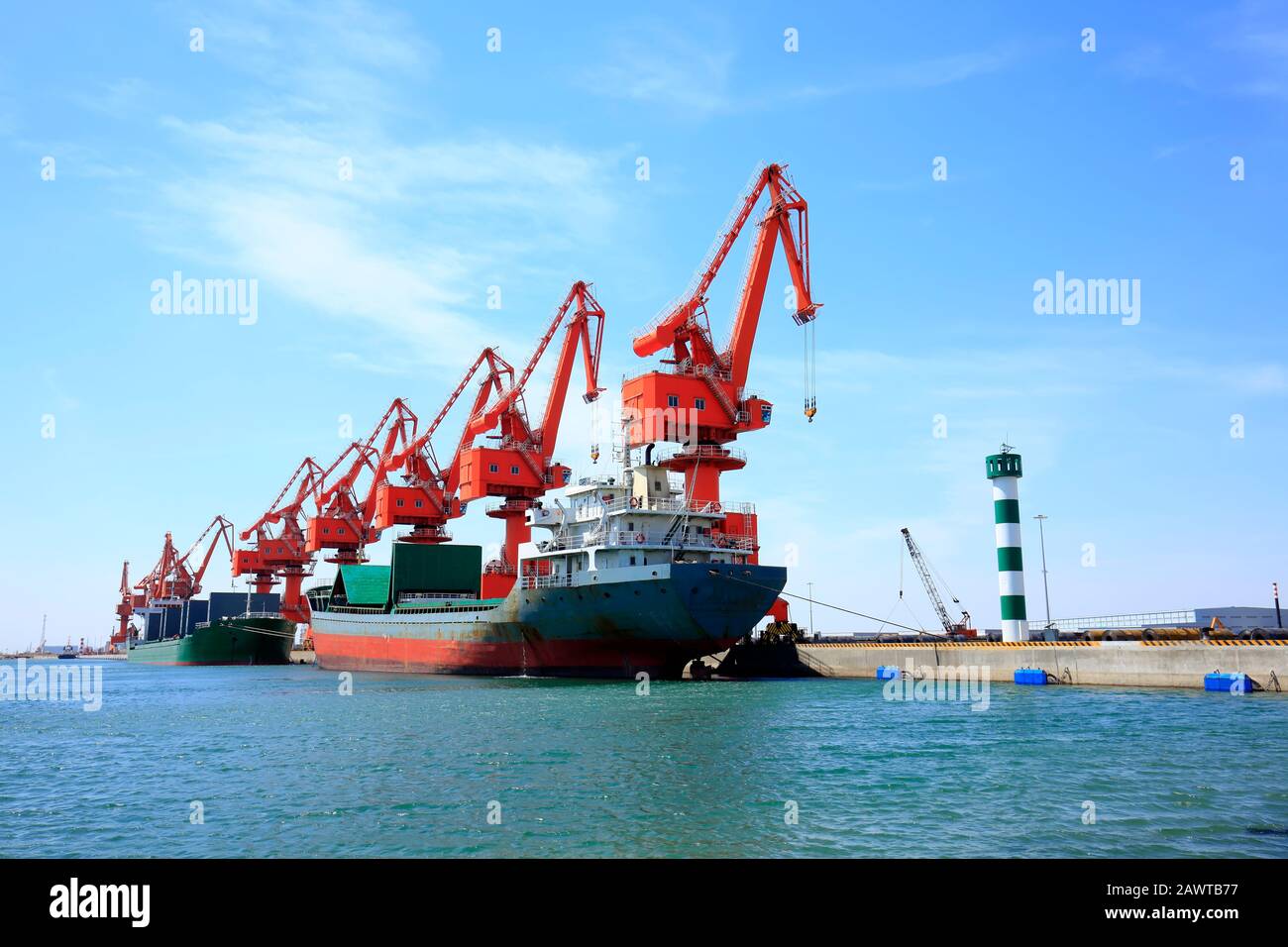 In freight terminal, gantry crane and cargo ships are in loading and ...