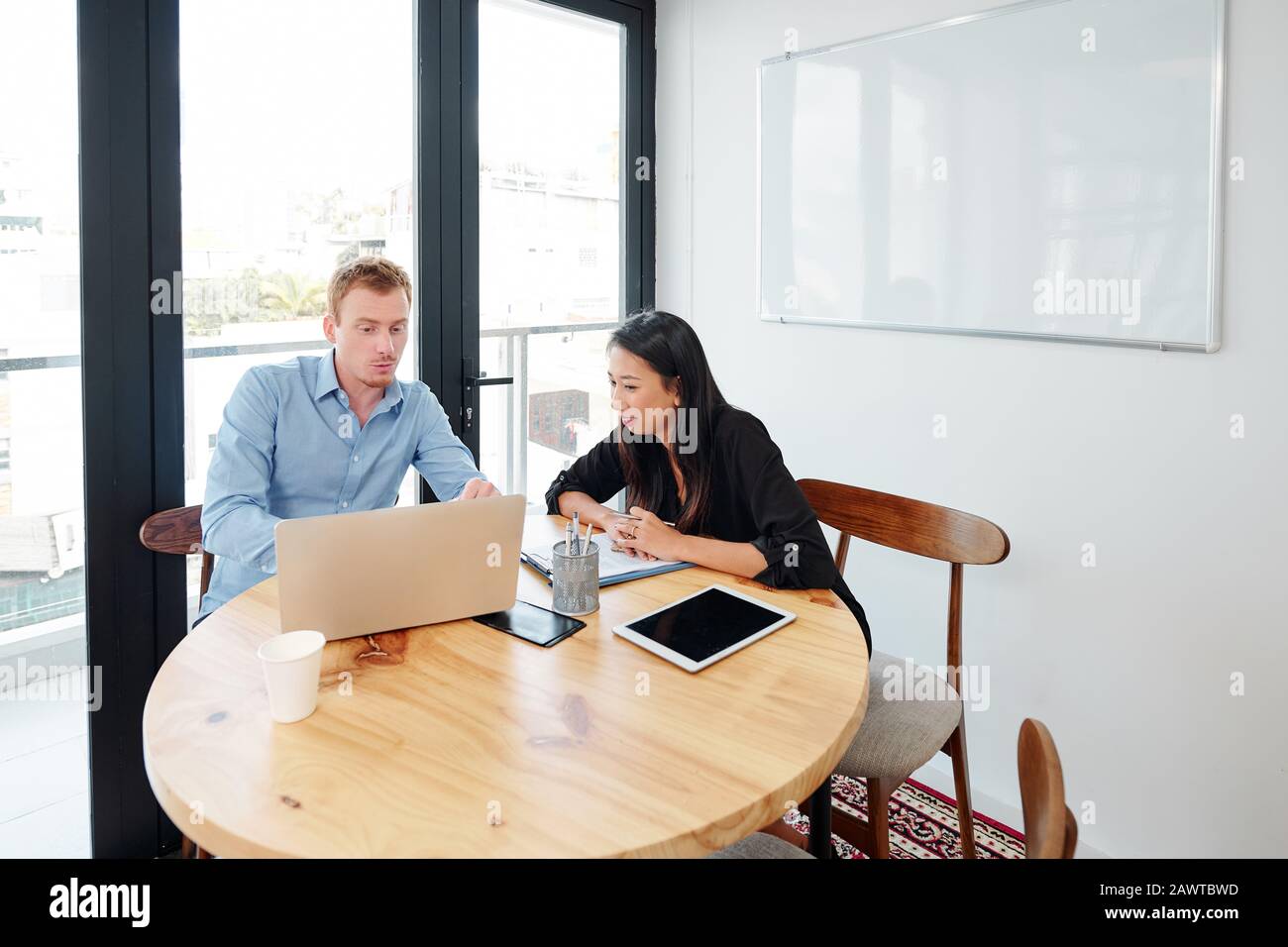 Software developers and project manager discussing prototype on new ...