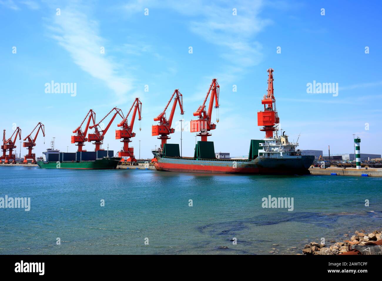 In freight terminal, gantry crane and cargo ships are in loading and ...