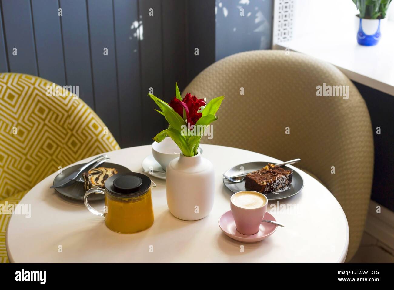 Breakfast with coffee, tea and pastries at a cozy table of a modern ...