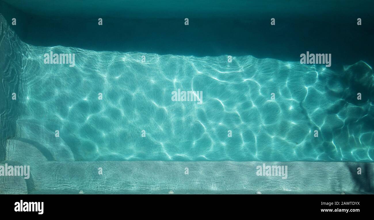 Blue clear water in swimming pool above top view Stock Photo - Alamy