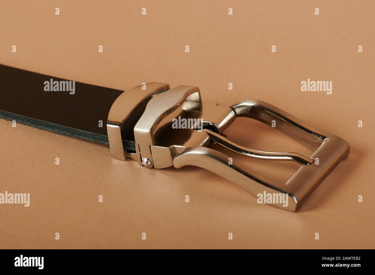 Metal leather belt buckle on beige color close up view Stock Photo - Alamy