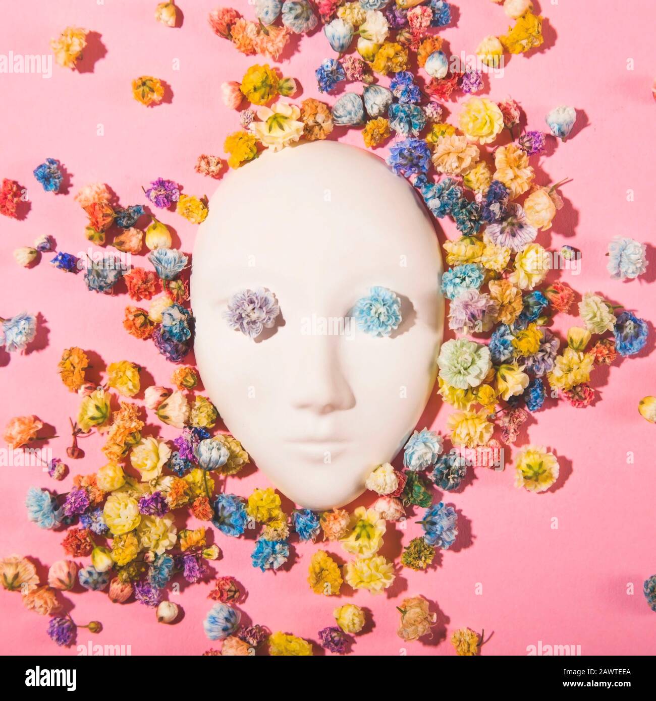 Woman face portrait among flowers and flowers in front of her eyes ...