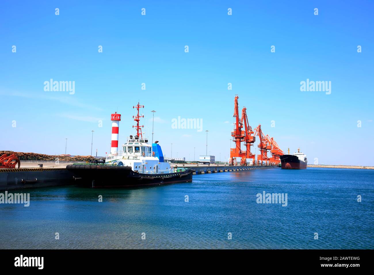 In freight terminal, gantry crane and cargo ships are in loading and ...