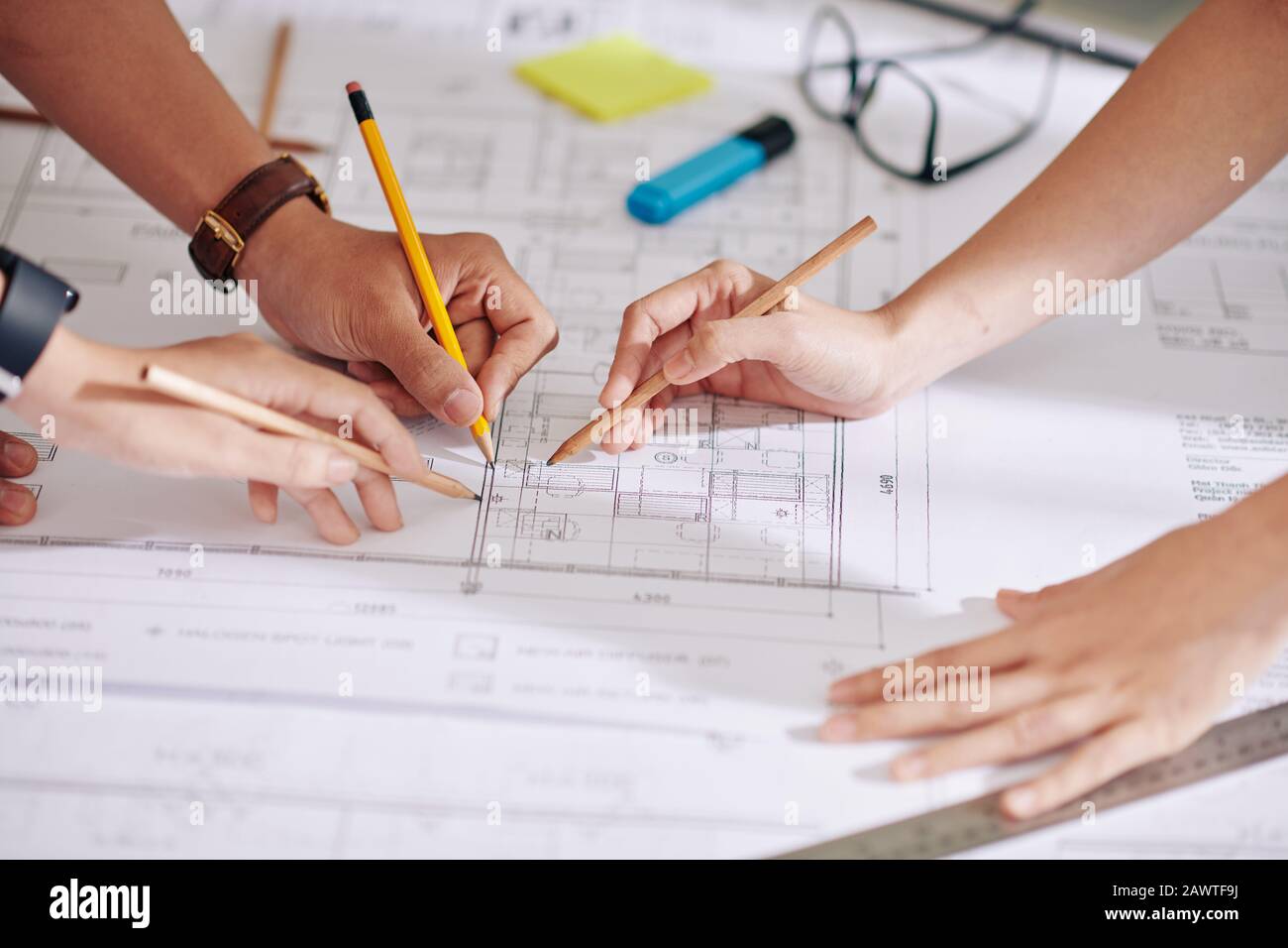 Team of designers and architects discussing project of new house and ...