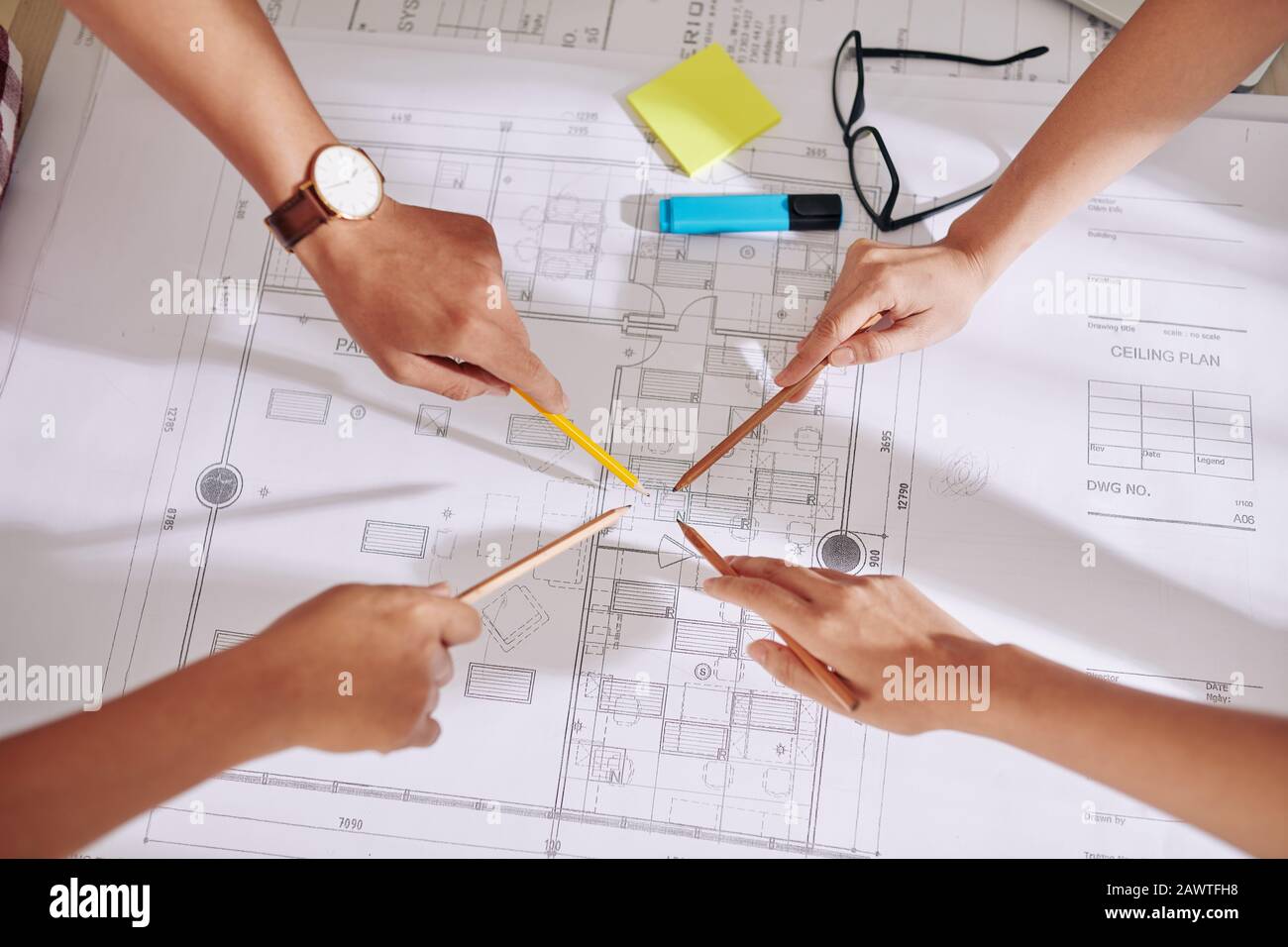 Hands of construction engineers and architects pointing at construction ...