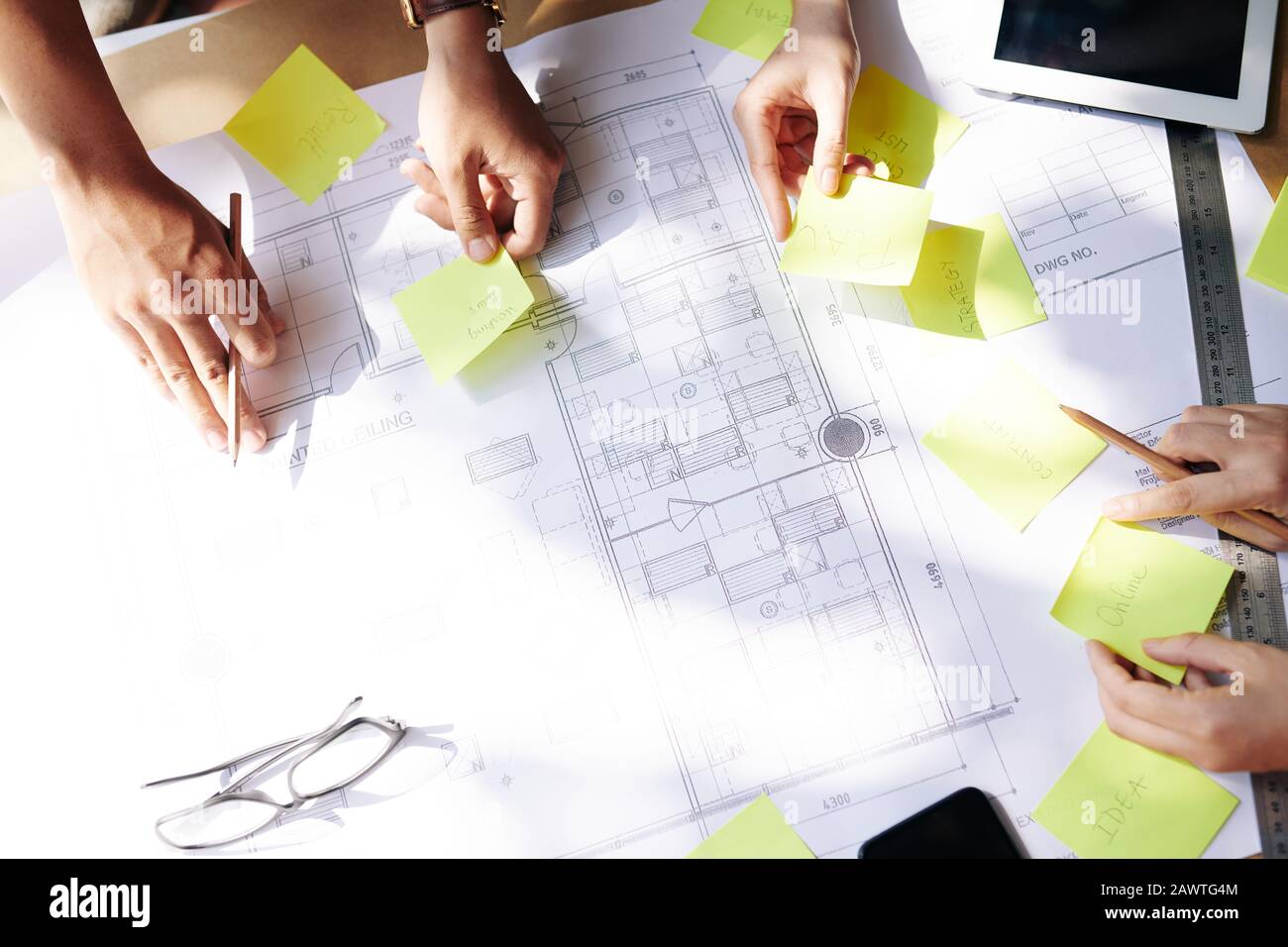 Team of architects planning work and sticking notes on construction ...