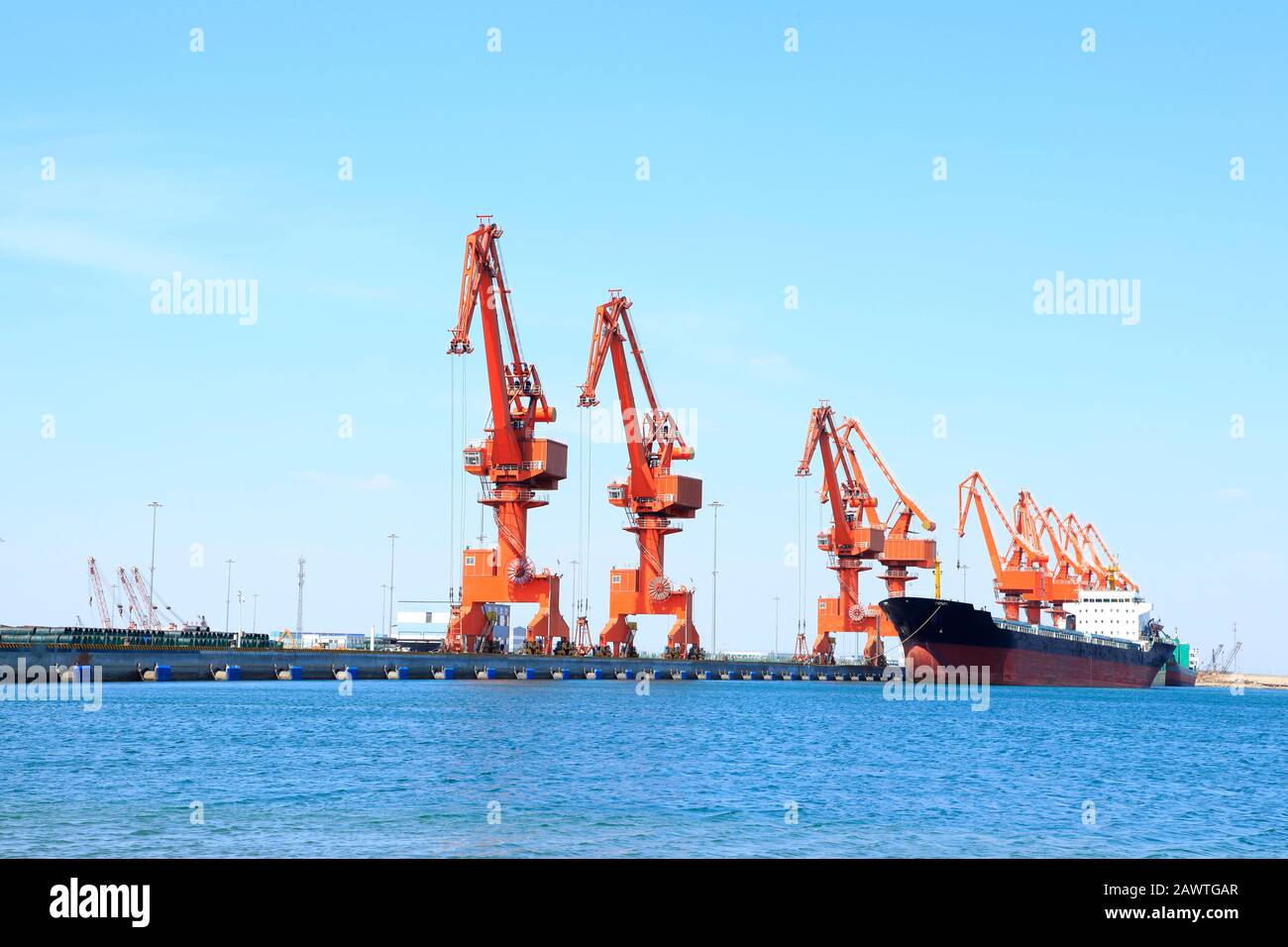 In freight terminal, gantry crane and cargo ships are in loading and ...