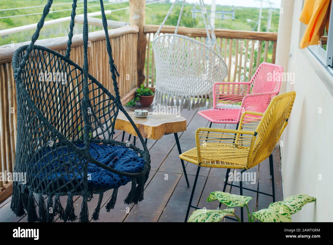 multi-colored wicker chairs on the balcony, mexico Stock Photo - Alamy