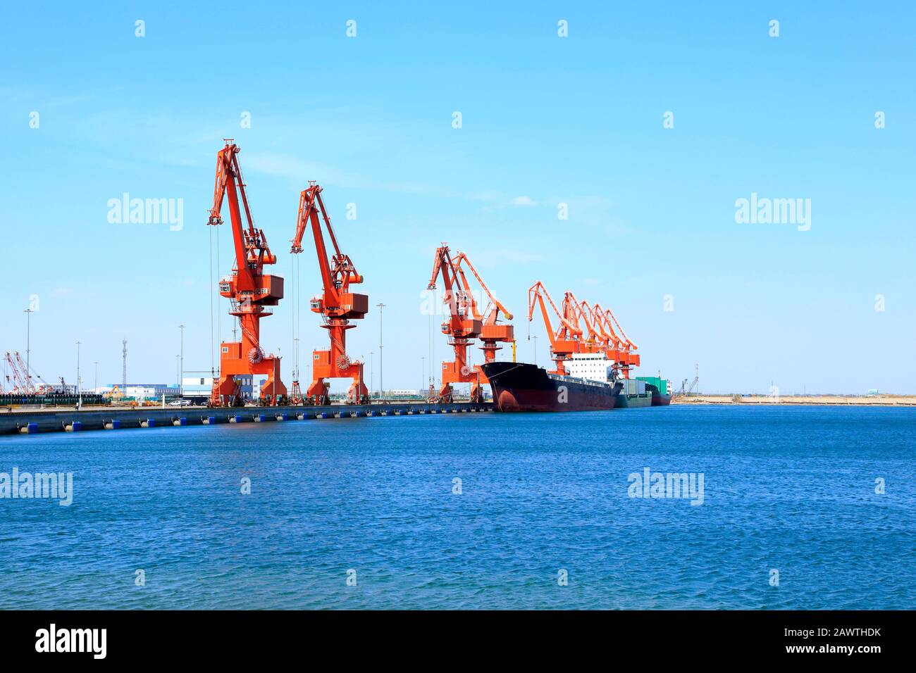 In freight terminal, gantry crane and cargo ships are in loading and ...