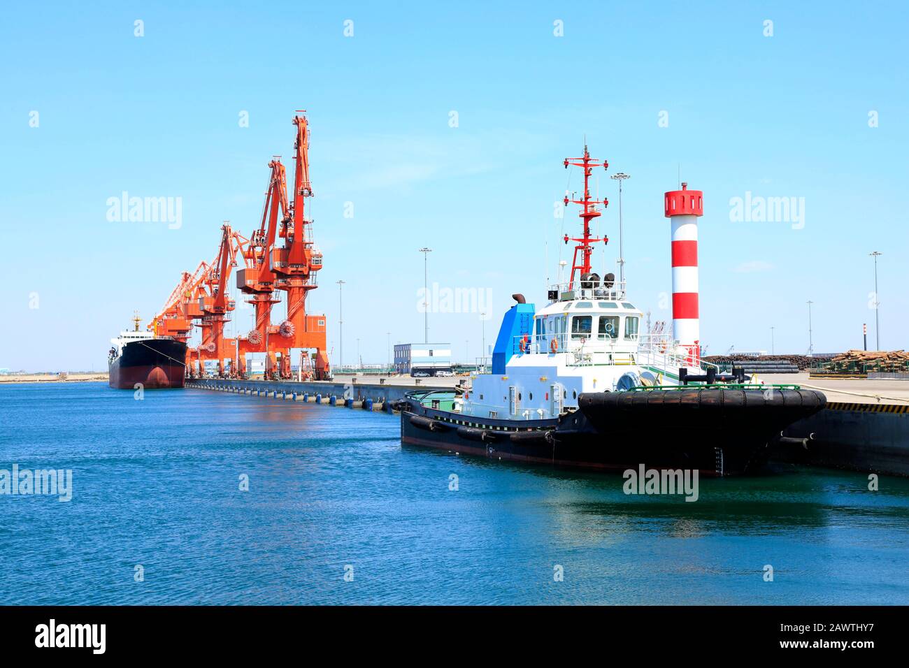 In freight terminal, gantry crane and cargo ships are in loading and ...