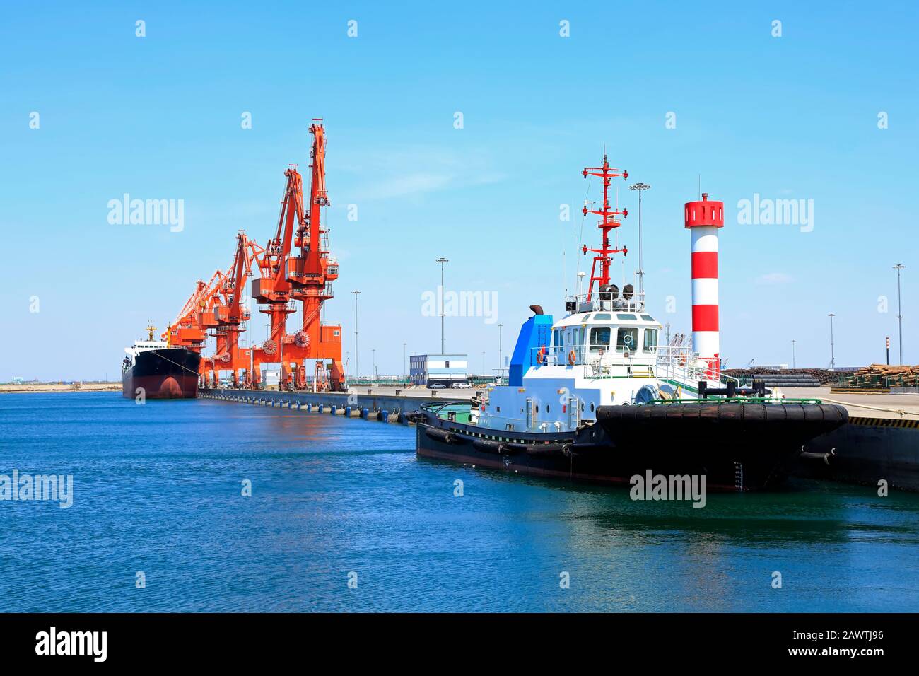 In freight terminal, gantry crane and cargo ships are in loading and ...