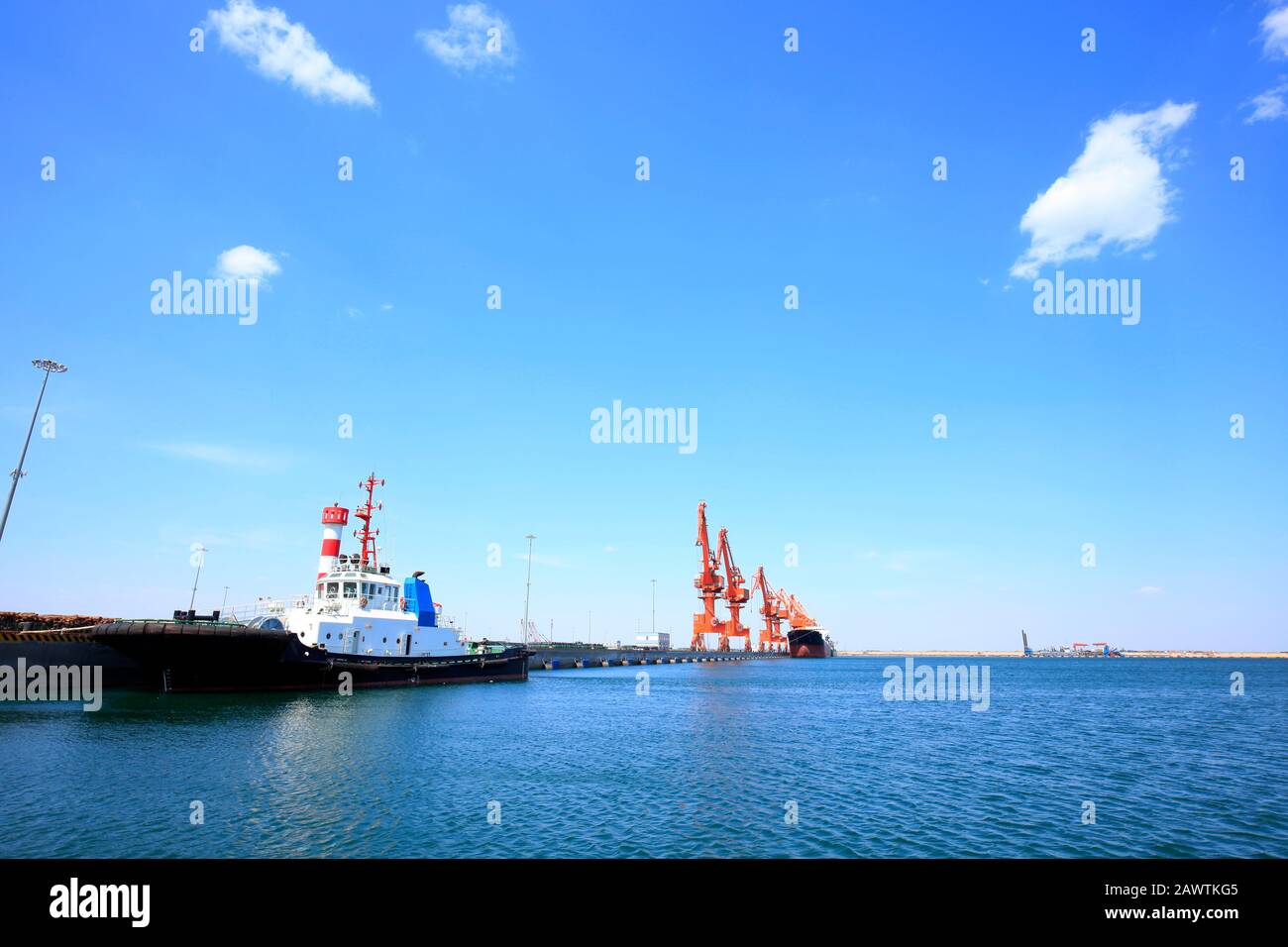 In freight terminal, gantry crane and cargo ships are in loading and ...