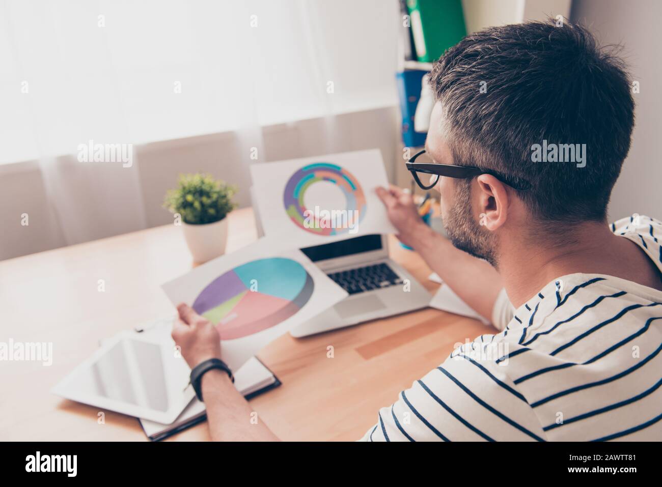 Back view of man in glasses looking on diagramas Stock Photo - Alamy