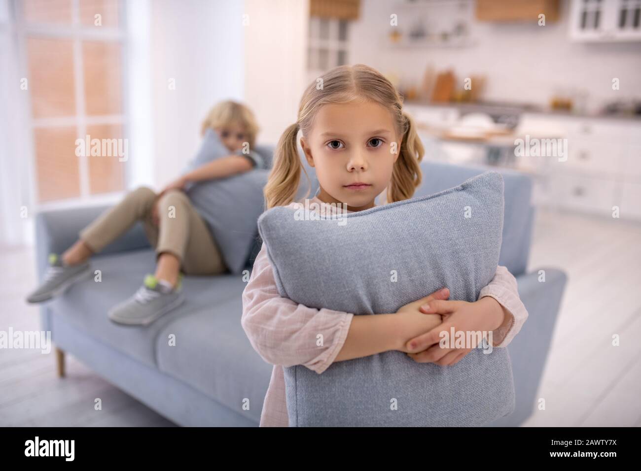 Blond sister and brother feeling sad after the conflict Stock Photo - Alamy