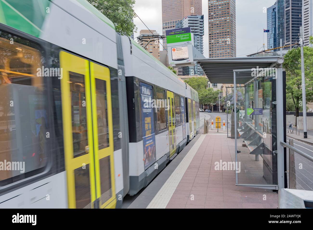A modern Melbourne tram leaves stop number 10 Parliament Station, one ...