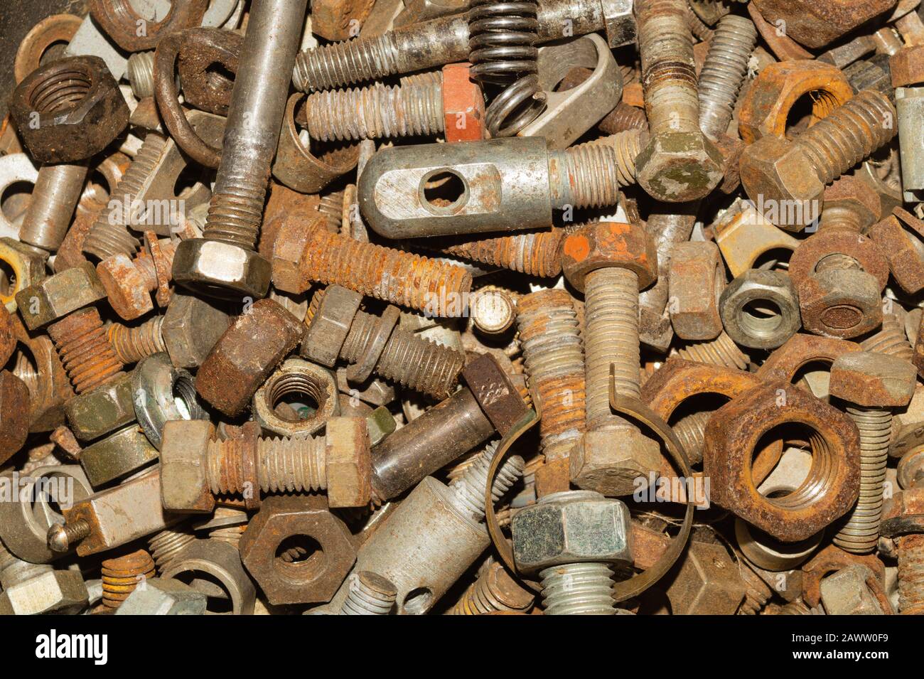 Rusty bolts and nuts of different sizes. scrap metal. industrial ...