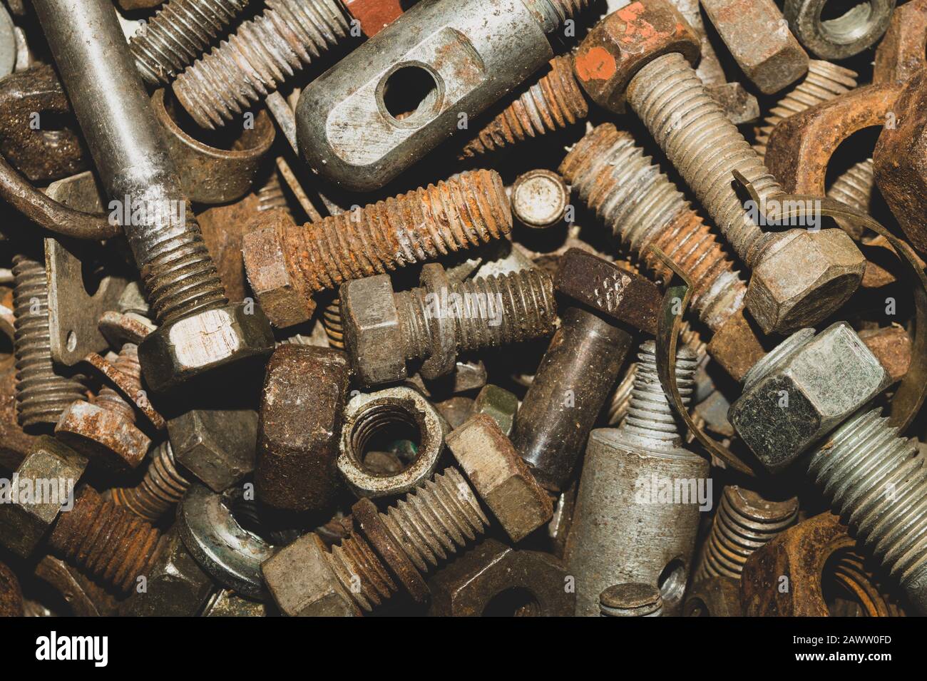 Rusty bolts and nuts of different sizes. scrap metal. industrial ...