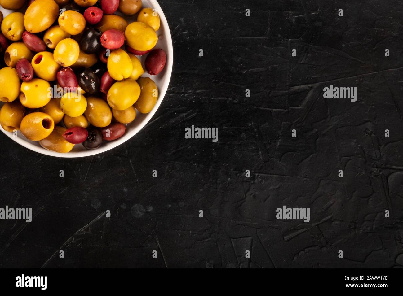 Olives variety close-up on a black background with copy space. Black ...